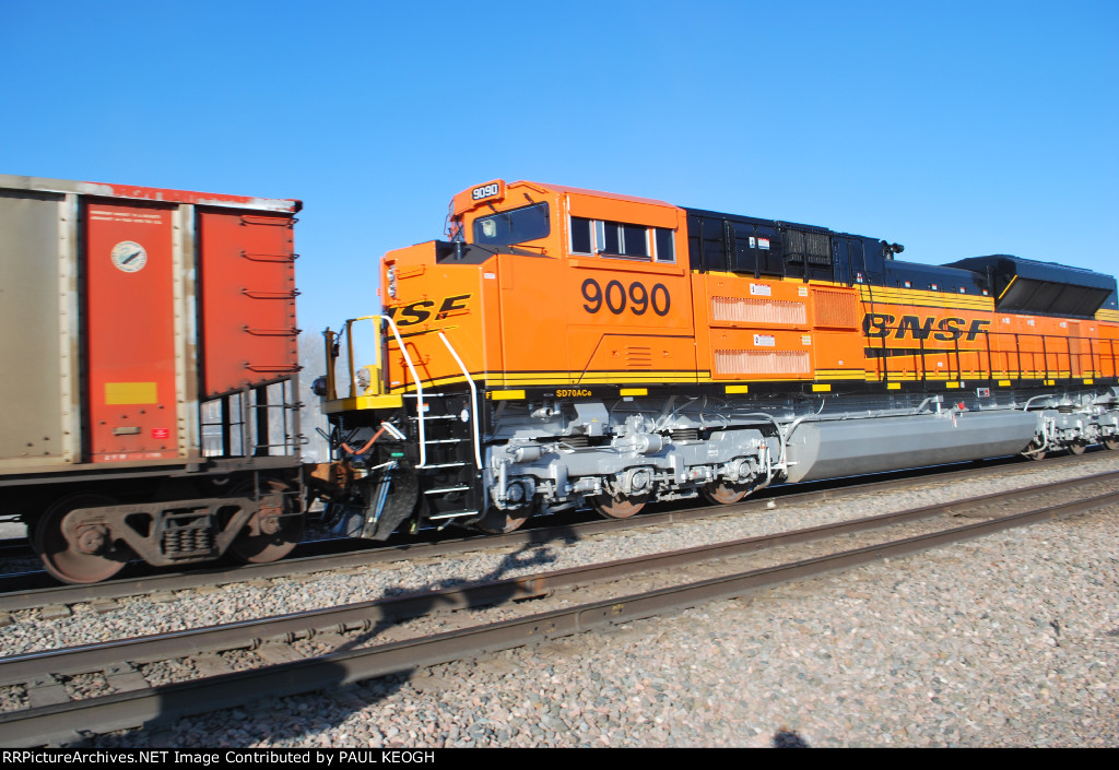 Close in shot of the Very Still Clean BNSF 9090 as she pushes a Empty Coal Train West towards ...